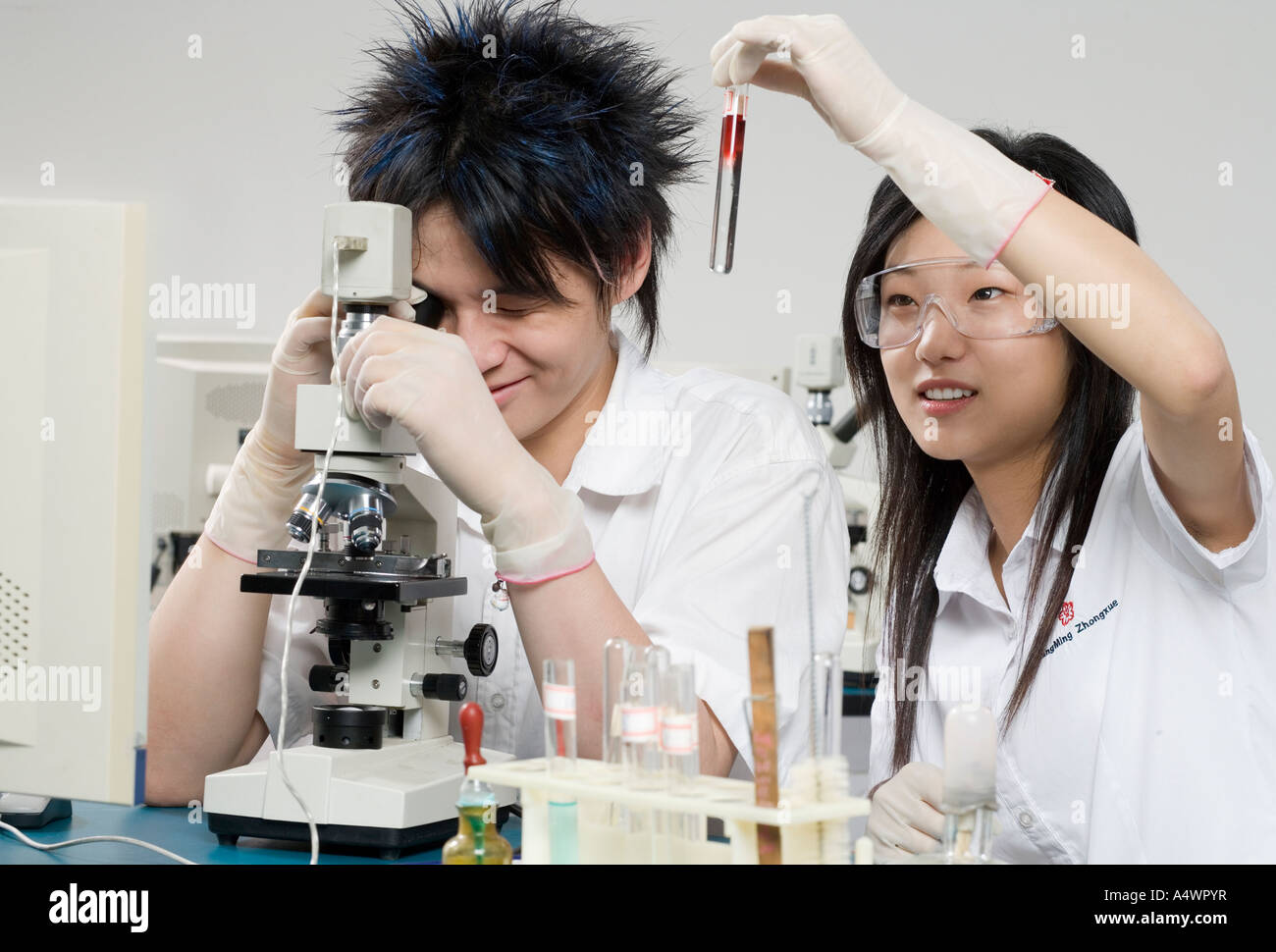 Students examining the contents of test tubes Stock Photo - Alamy