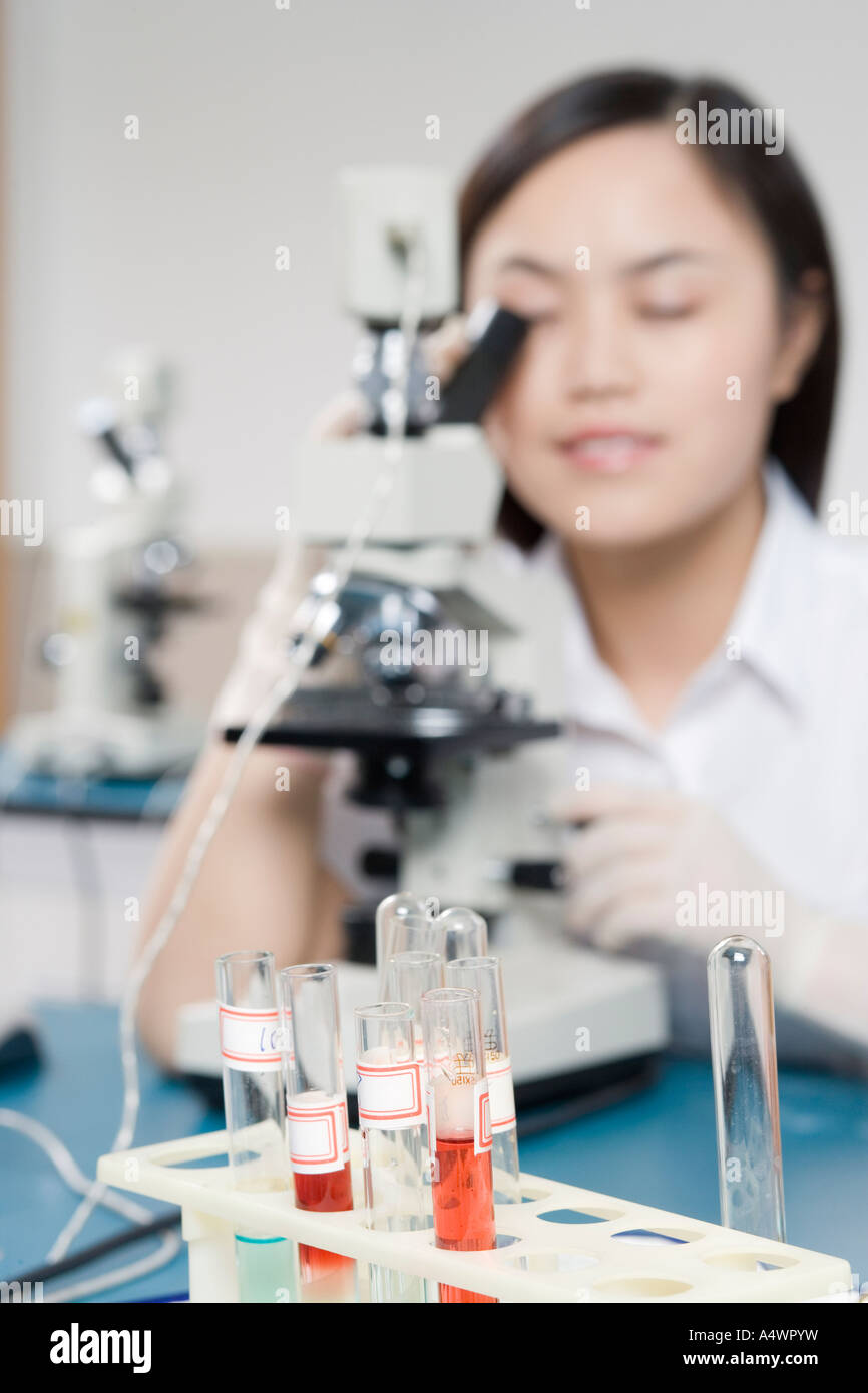 Female student using a microscope Stock Photo - Alamy