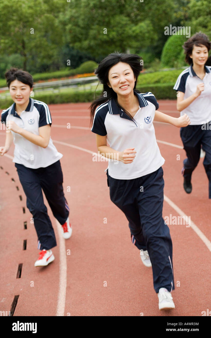 Female students running on race track Stock Photo - Alamy
