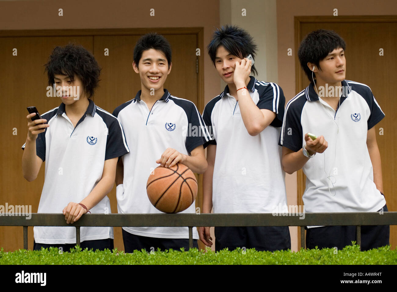 Male students using their cell phones Stock Photo - Alamy