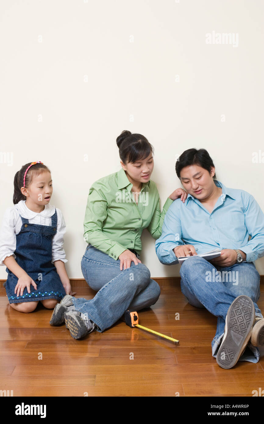 Family making plans for new apartment Stock Photo - Alamy