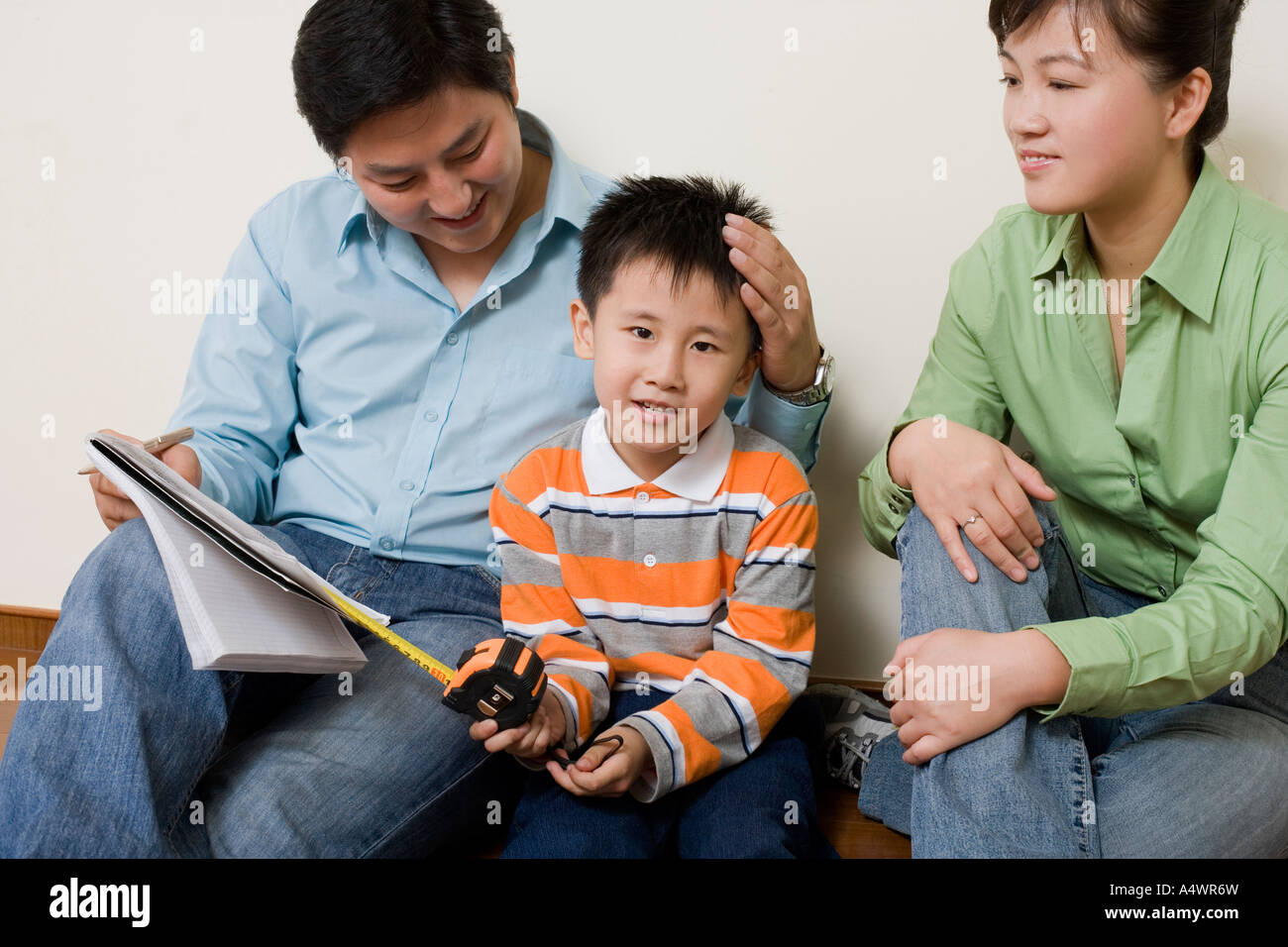 Family making plans for new apartment Stock Photo - Alamy