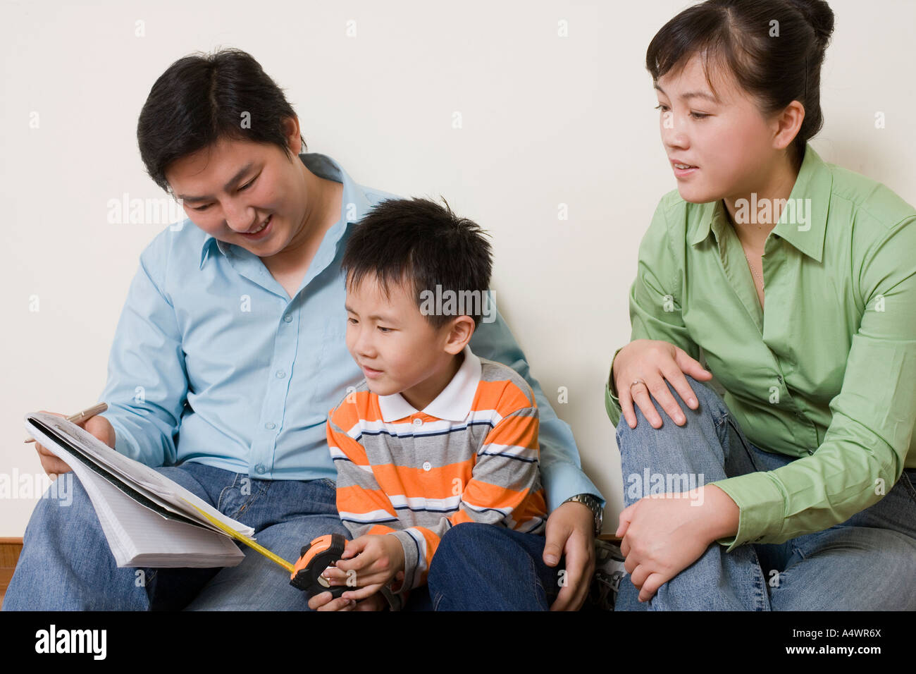Family making plans for new apartment Stock Photo - Alamy