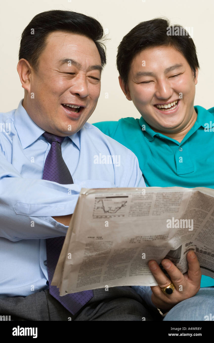 Father son reading newspaper hi-res stock photography and images - Alamy