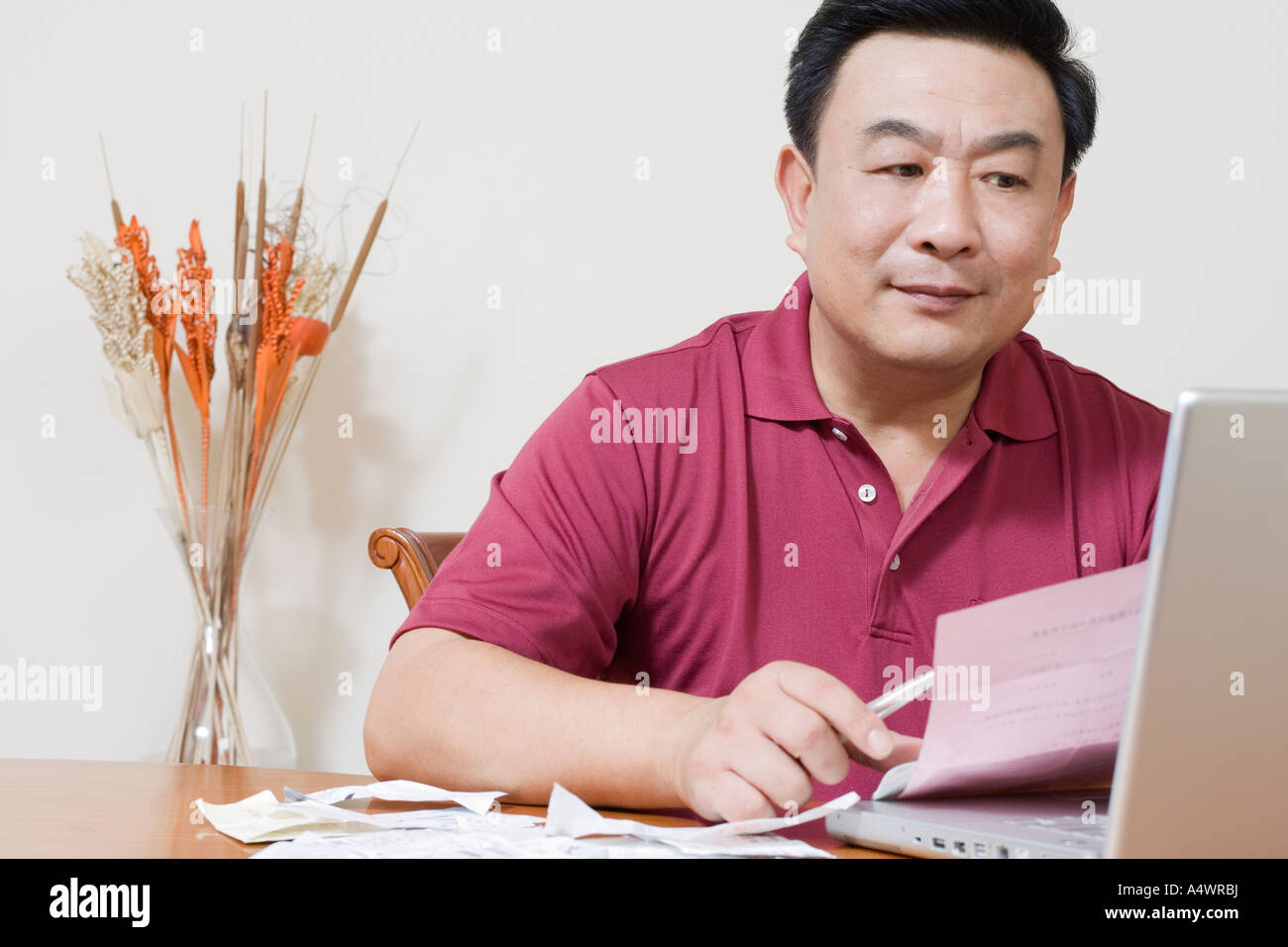 Middle-aged man using laptop Stock Photo - Alamy