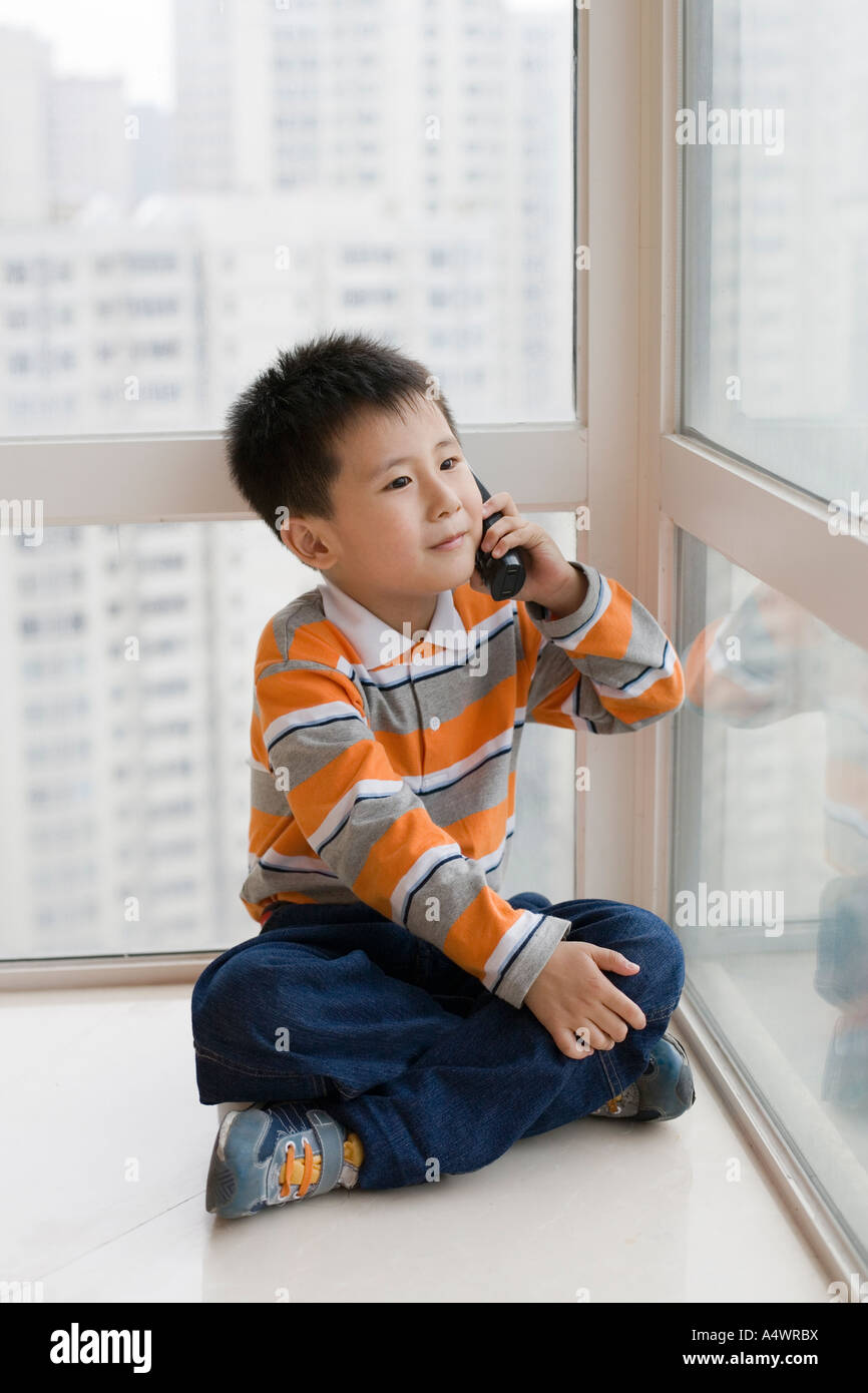 Young boy talking on the telephone Stock Photo - Alamy