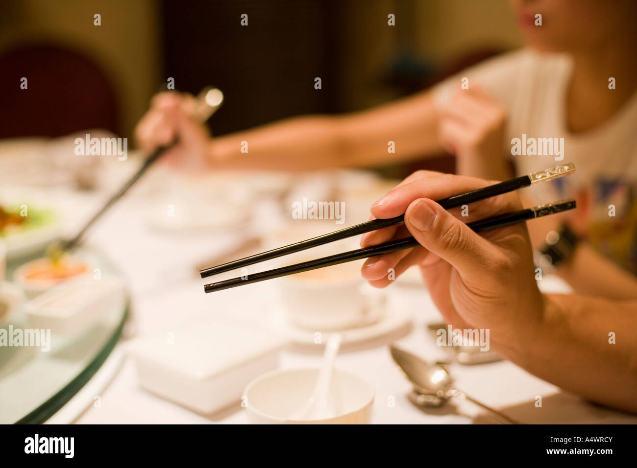 Person using chopsticks Stock Photo - Alamy