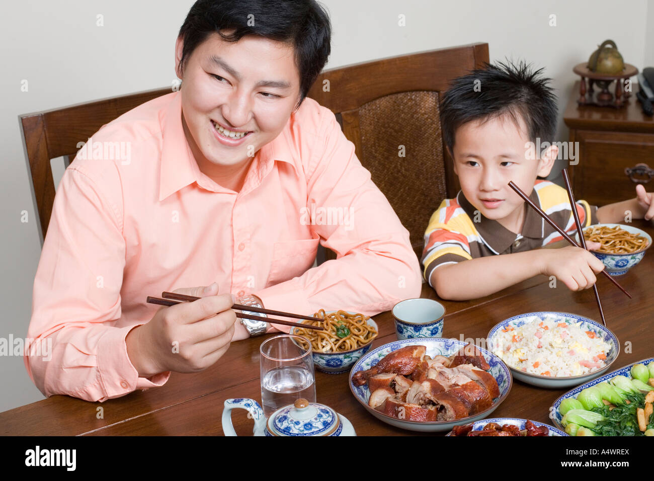 Father and son eating dinner Stock Photo - Alamy