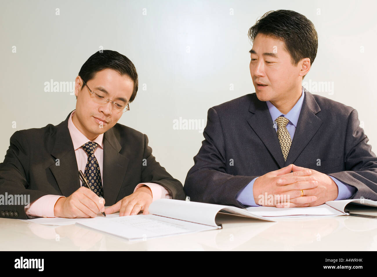 Businessmen talking in a meeting Stock Photo - Alamy