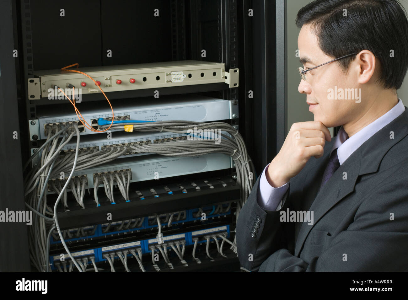 Businessman examining computer server Stock Photo - Alamy