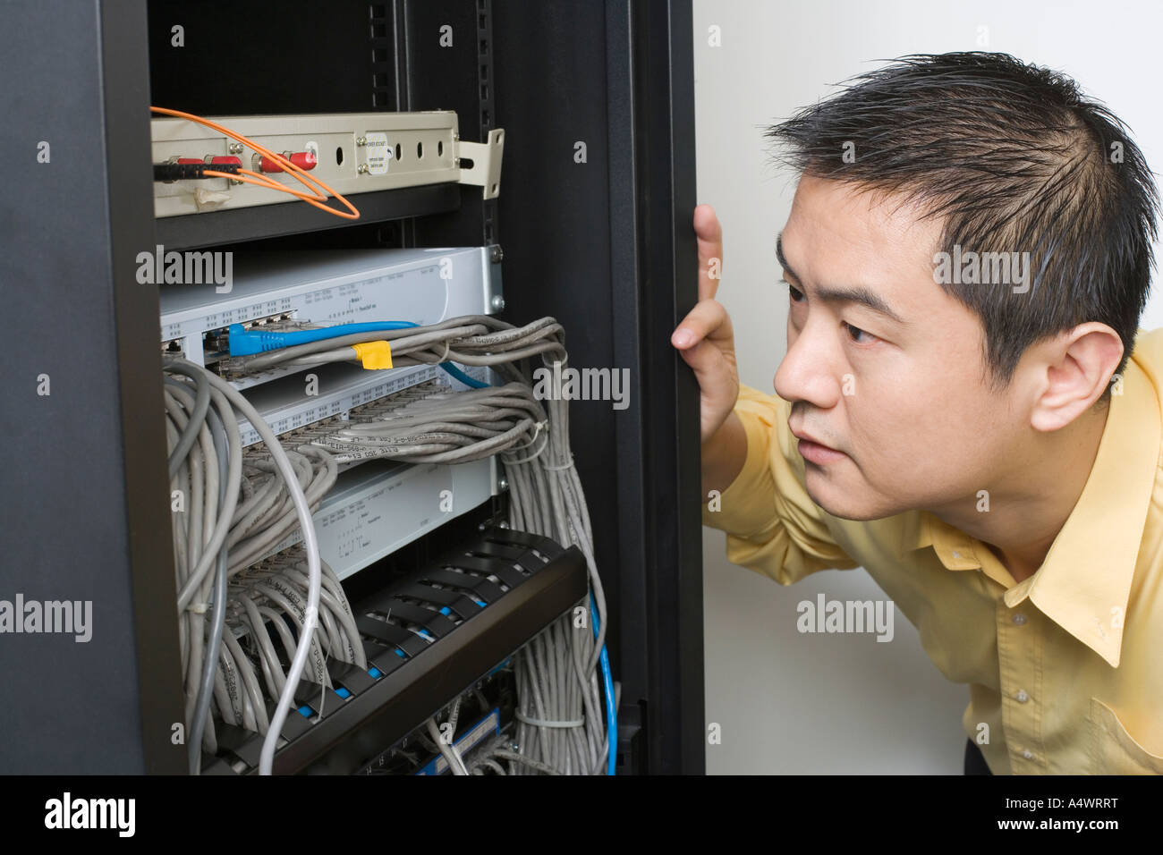 Businessman examining a computer server Stock Photo - Alamy