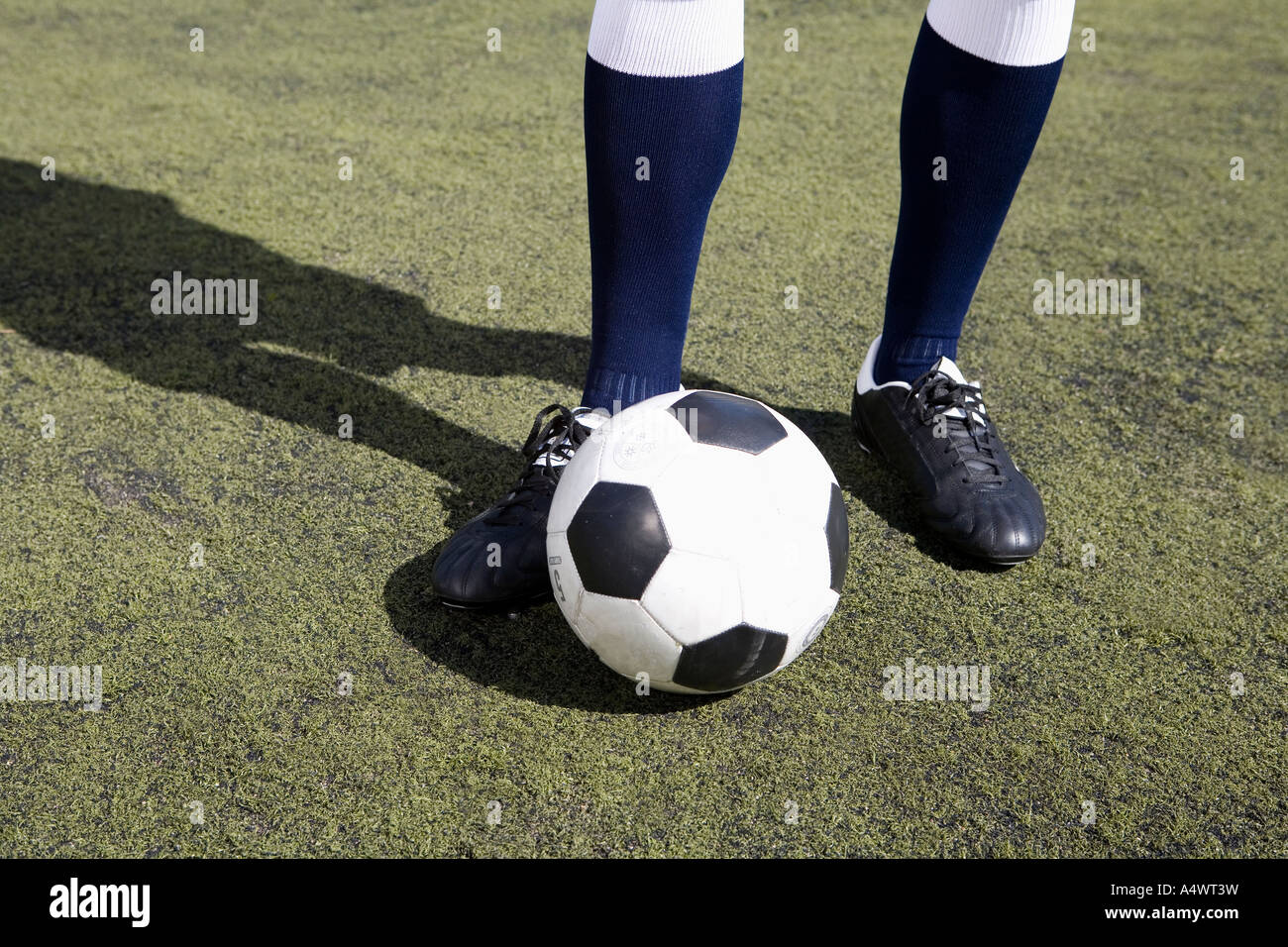 Soccer player standing on field Stock Photo - Alamy