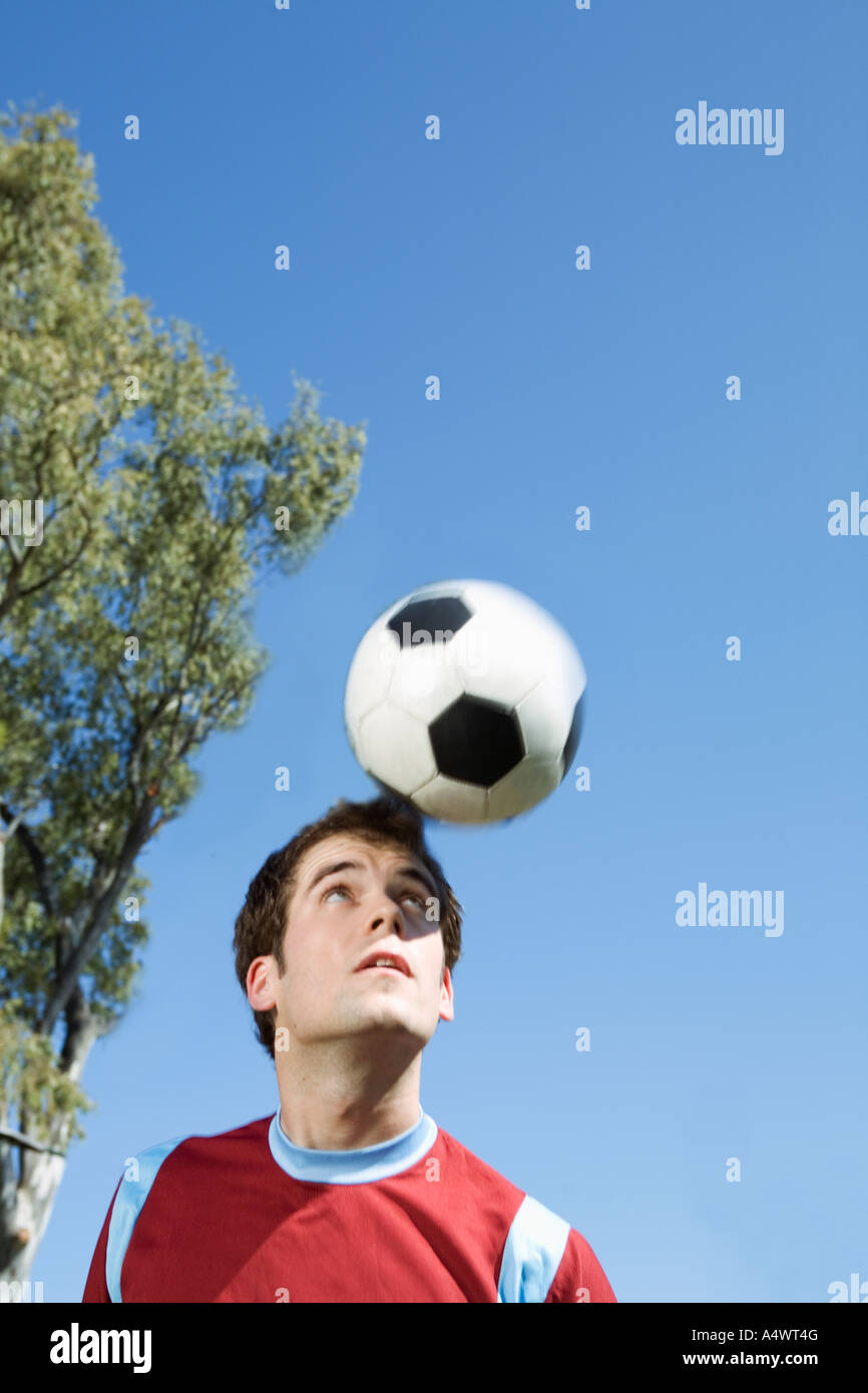 Man heading a soccer ball Stock Photo - Alamy