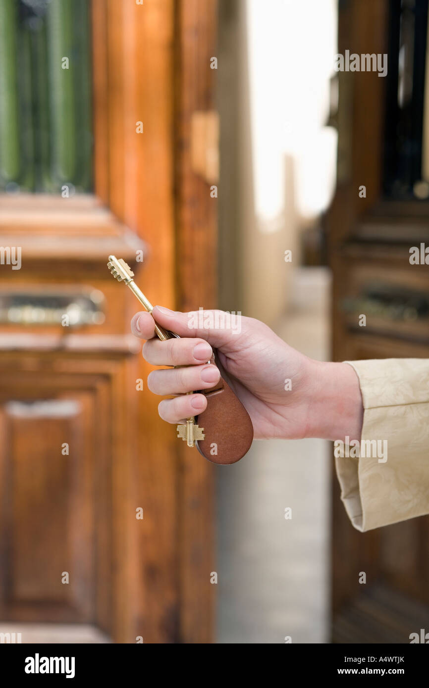 Woman holding skeleton key Stock Photo - Alamy