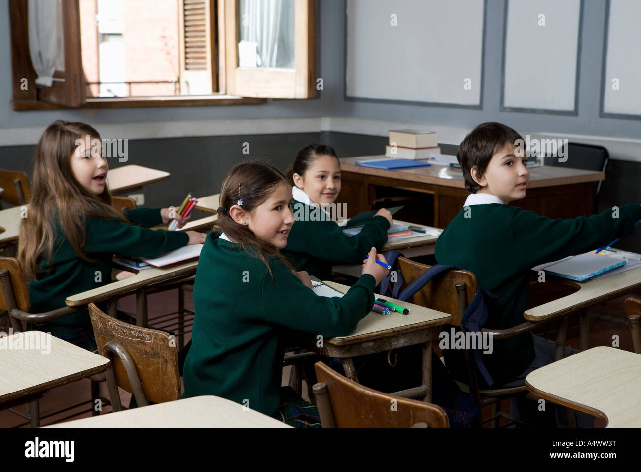 Young students sitting at their desks in class Stock Photo - Alamy