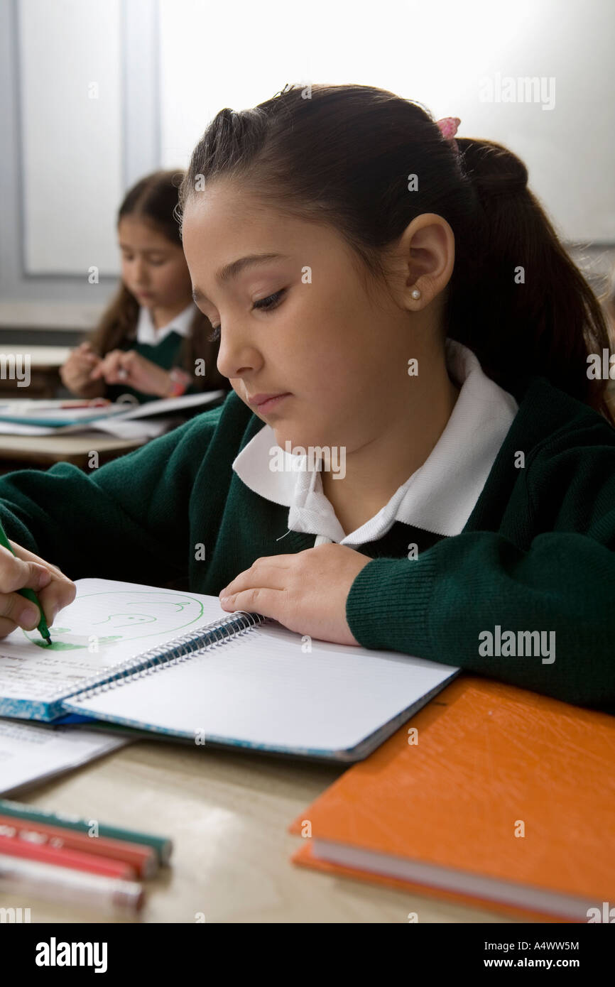 Young student taking notes in class Stock Photo - Alamy