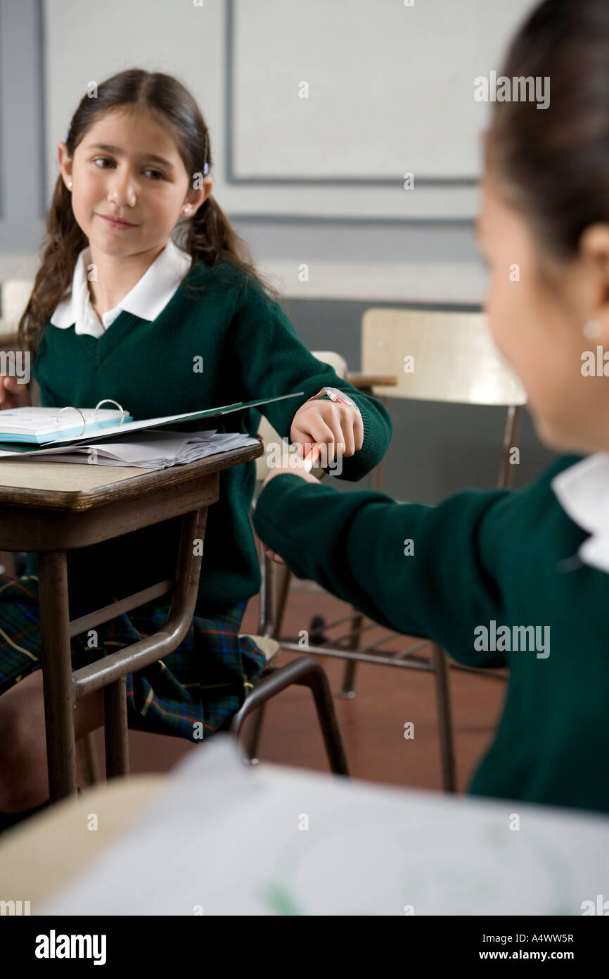 Young student handing a marker to classmate Stock Photo - Alamy