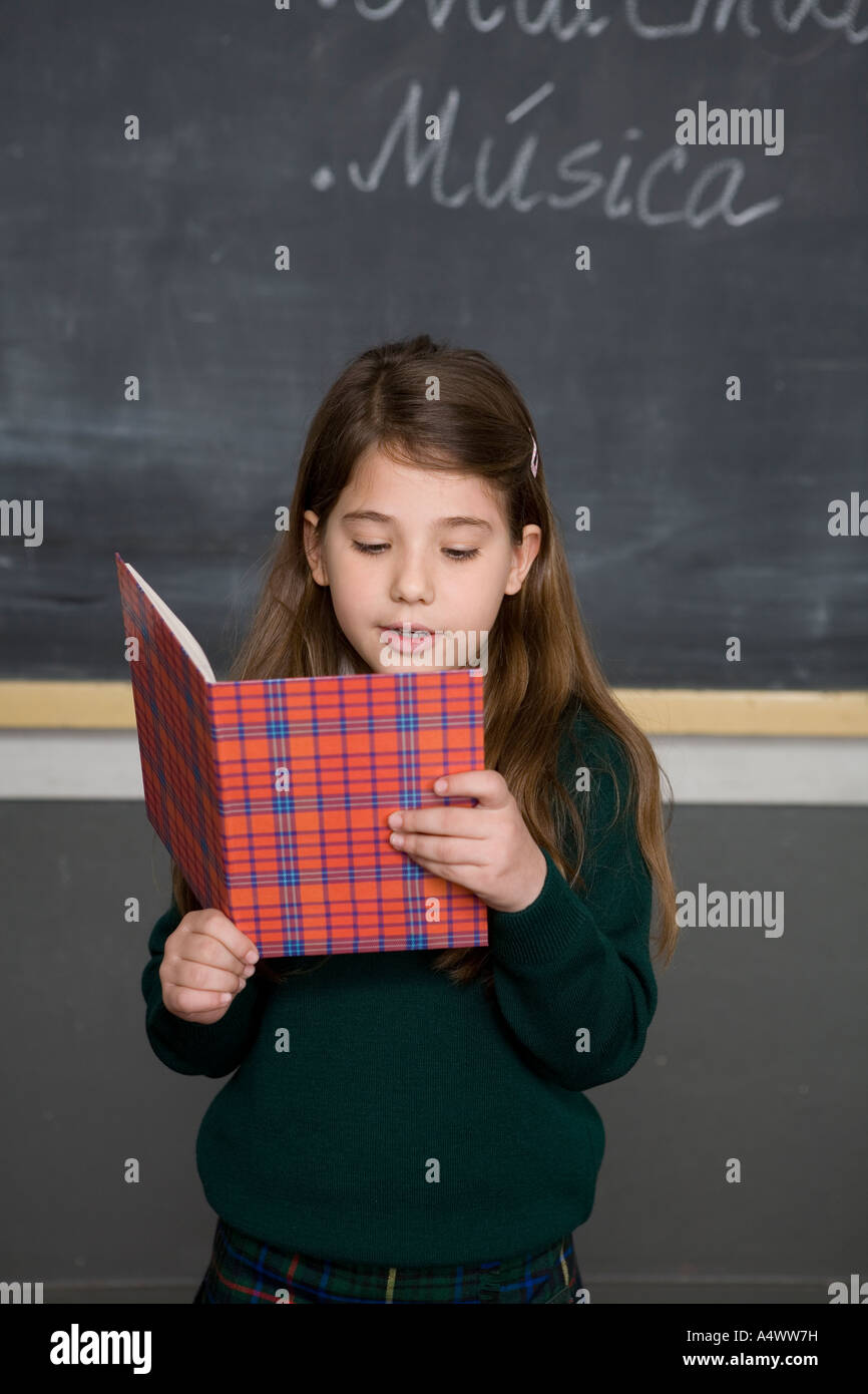 Young student reading in front of the class Stock Photo - Alamy