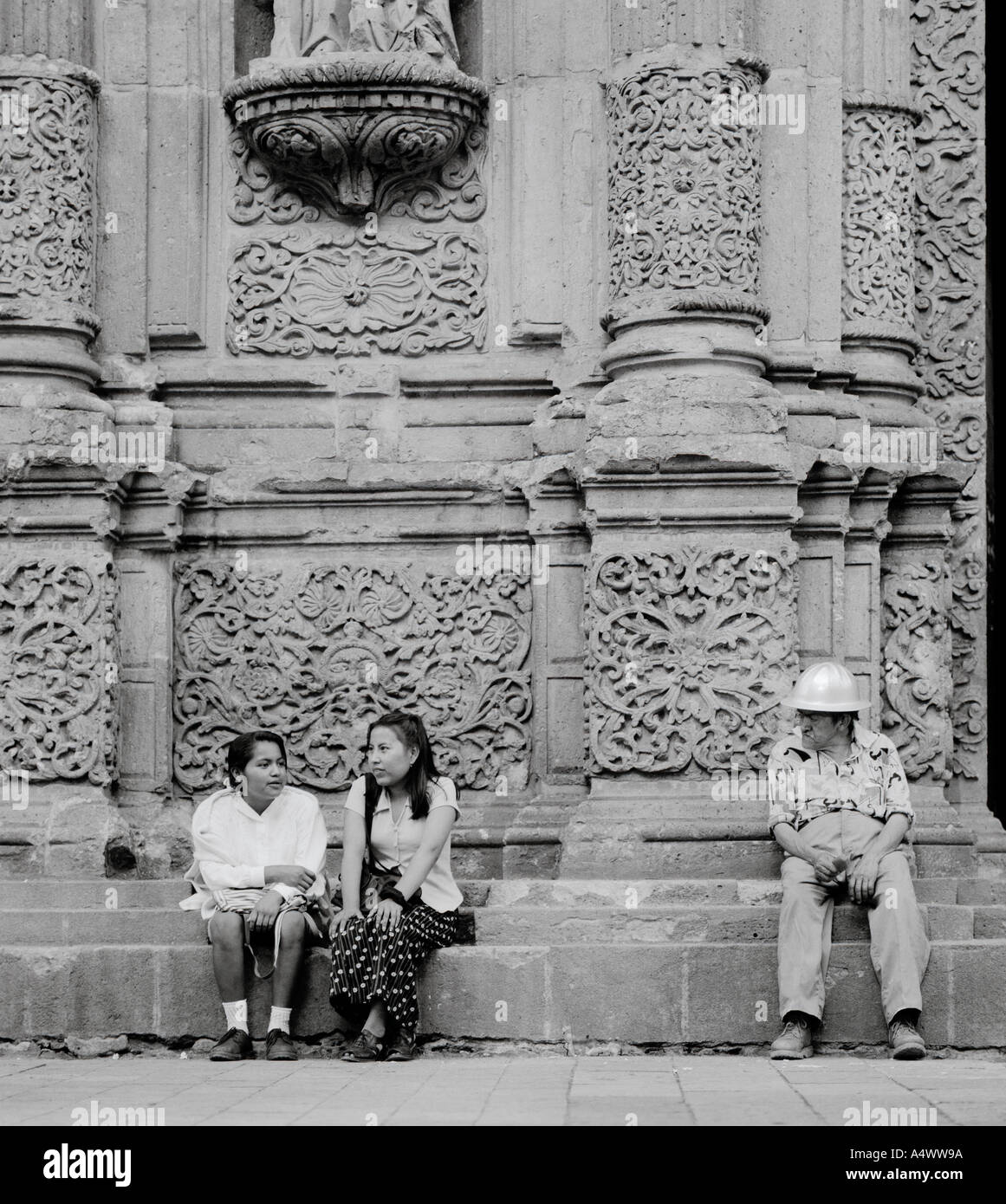 Mexican people in a street scene outside the cathedral in Oaxaca City ...