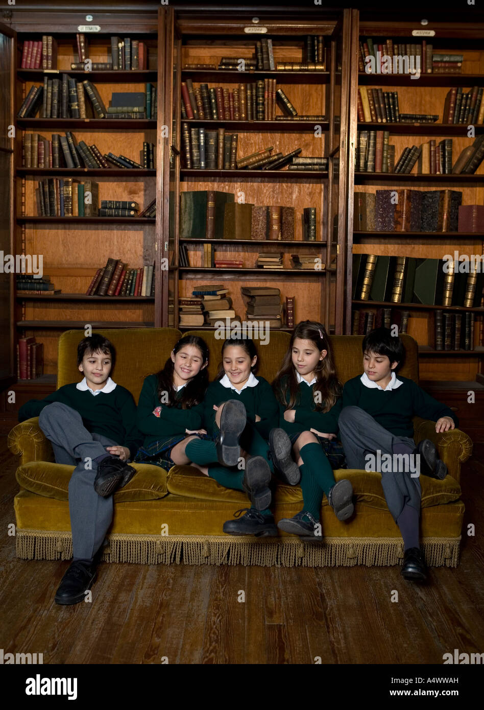 Young students sitting together on sofa Stock Photo - Alamy