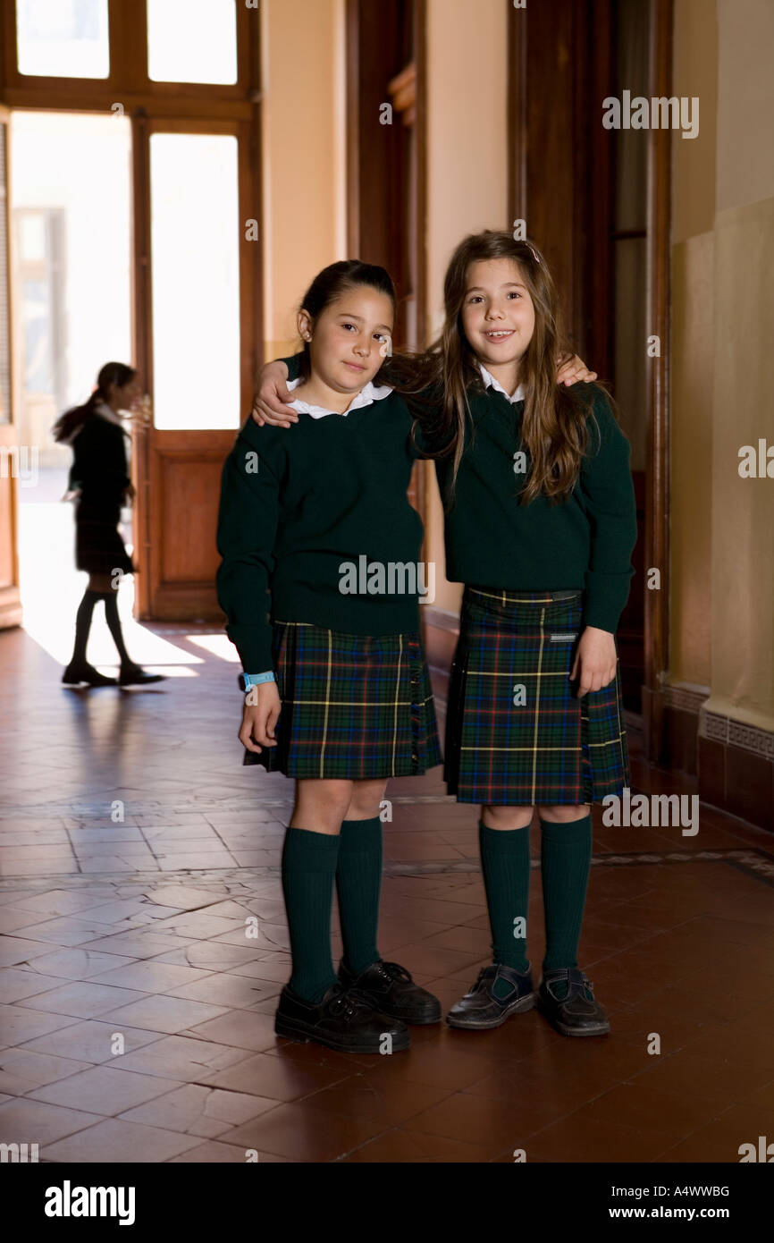 Female students hugging in school hallway Stock Photo - Alamy