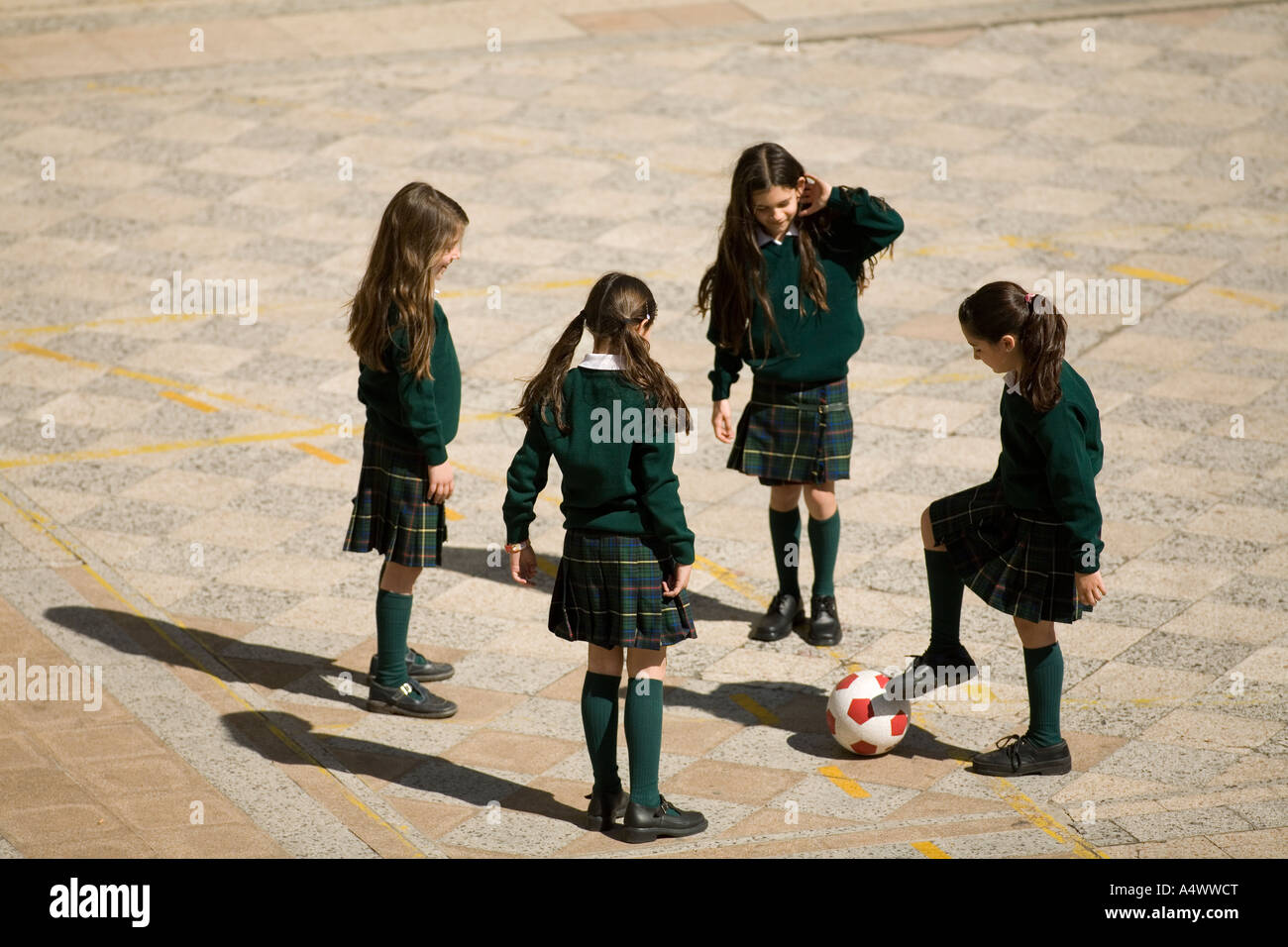 Students playing soccer in courtyard Stock Photo - Alamy
