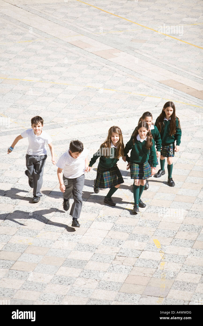 Young students running around courtyard Stock Photo - Alamy