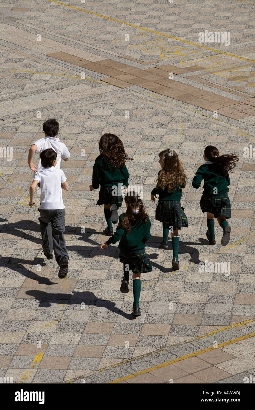 Young students running around courtyard Stock Photo - Alamy