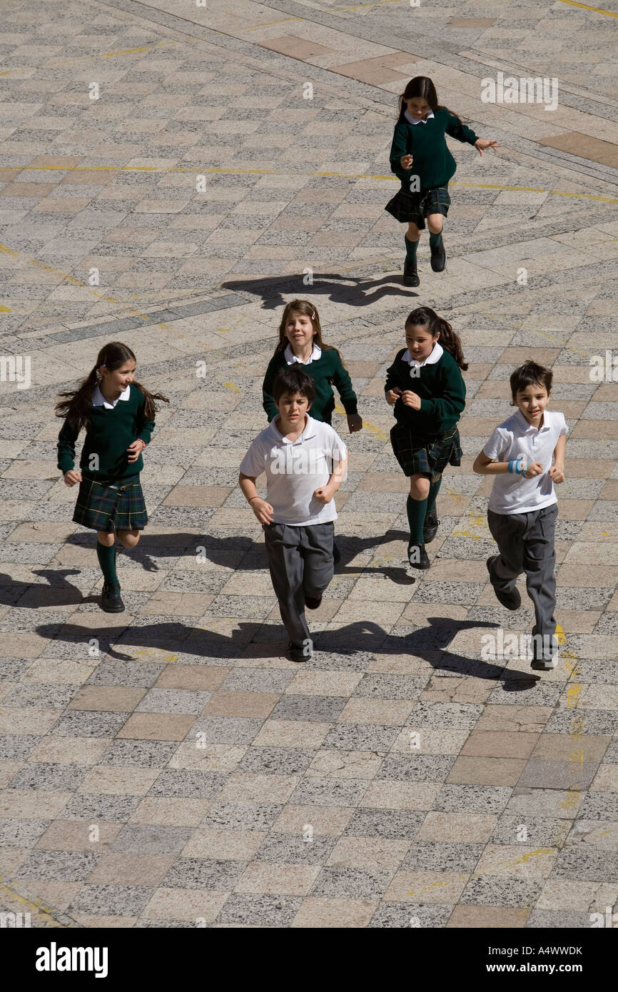 Young students running around courtyard Stock Photo - Alamy
