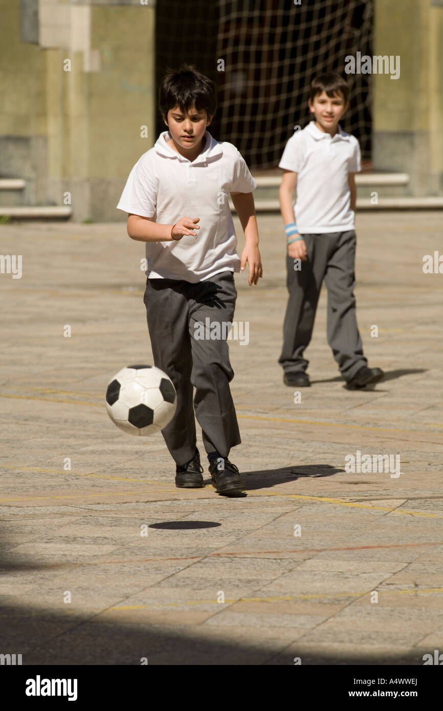 Boys playing soccer uniform playground hi-res stock photography and ...