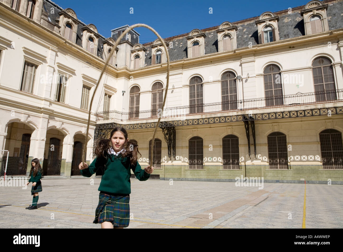 Young student jumping rope in courtyard Stock Photo - Alamy