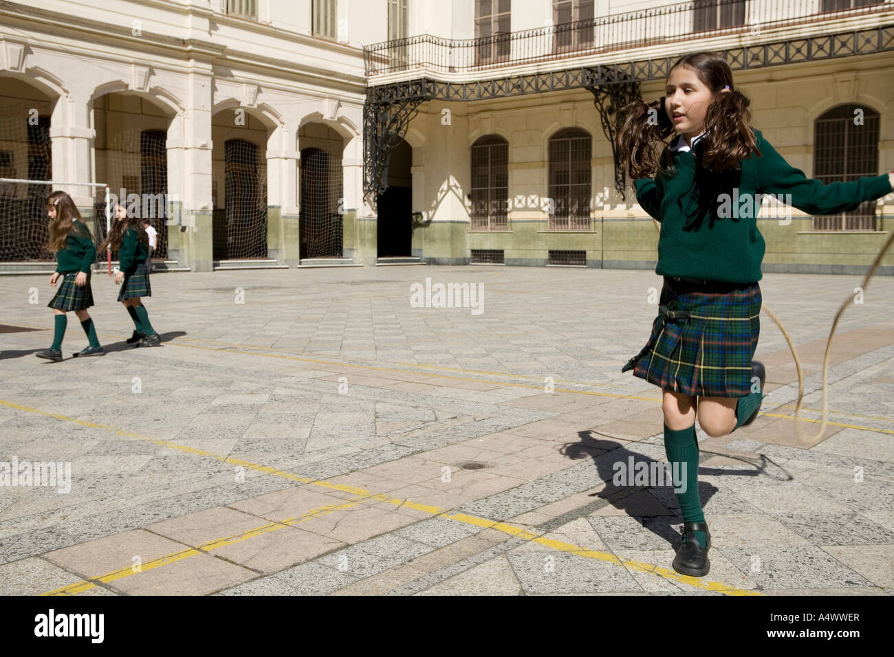 Young student jumping rope in courtyard Stock Photo - Alamy