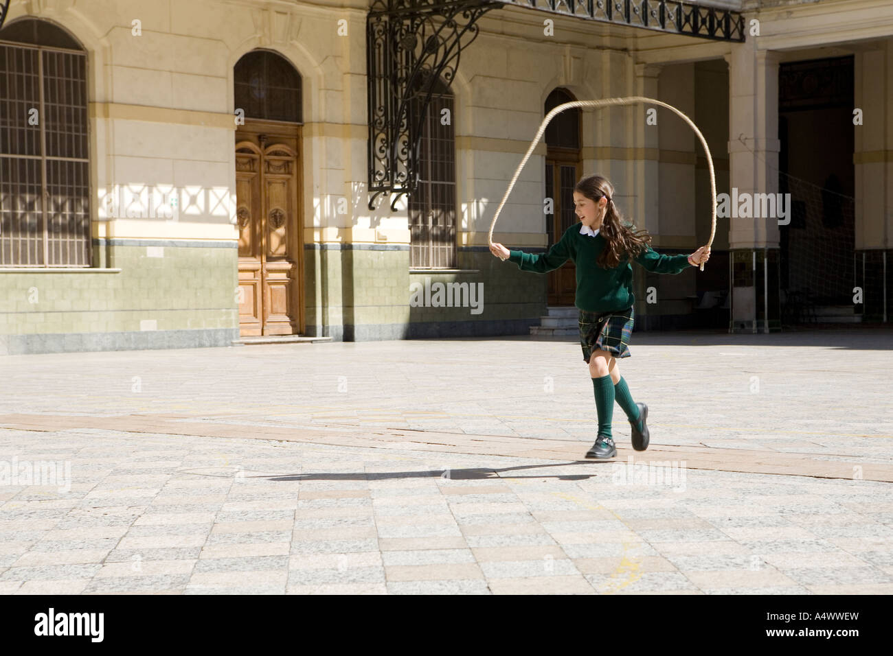 Young student jumping rope in courtyard Stock Photo - Alamy