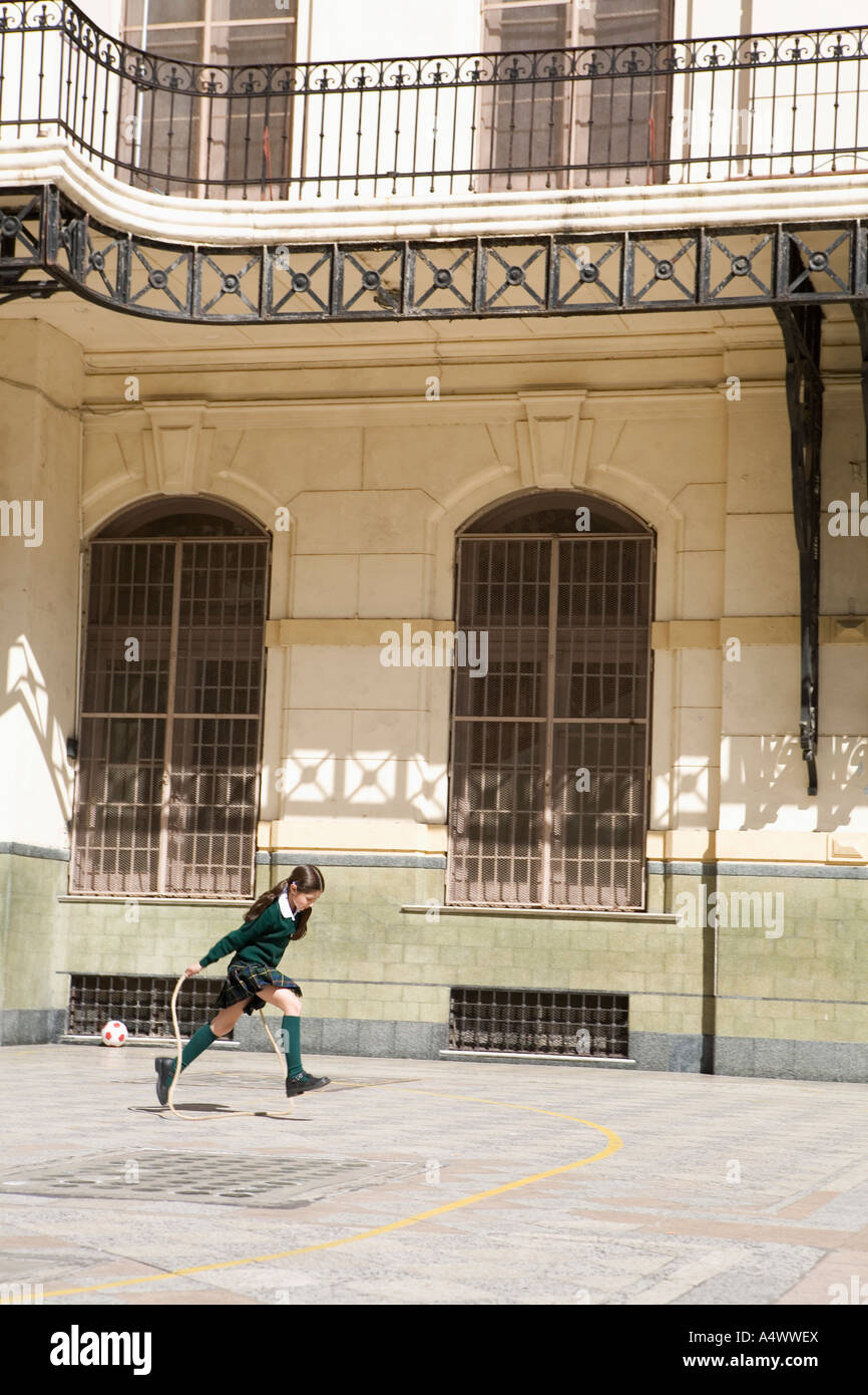 Young student jumping rope in courtyard Stock Photo - Alamy
