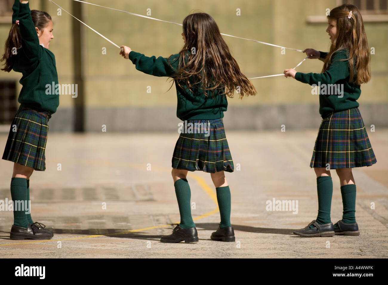 Three girls playing jump rope hi-res stock photography and images - Alamy