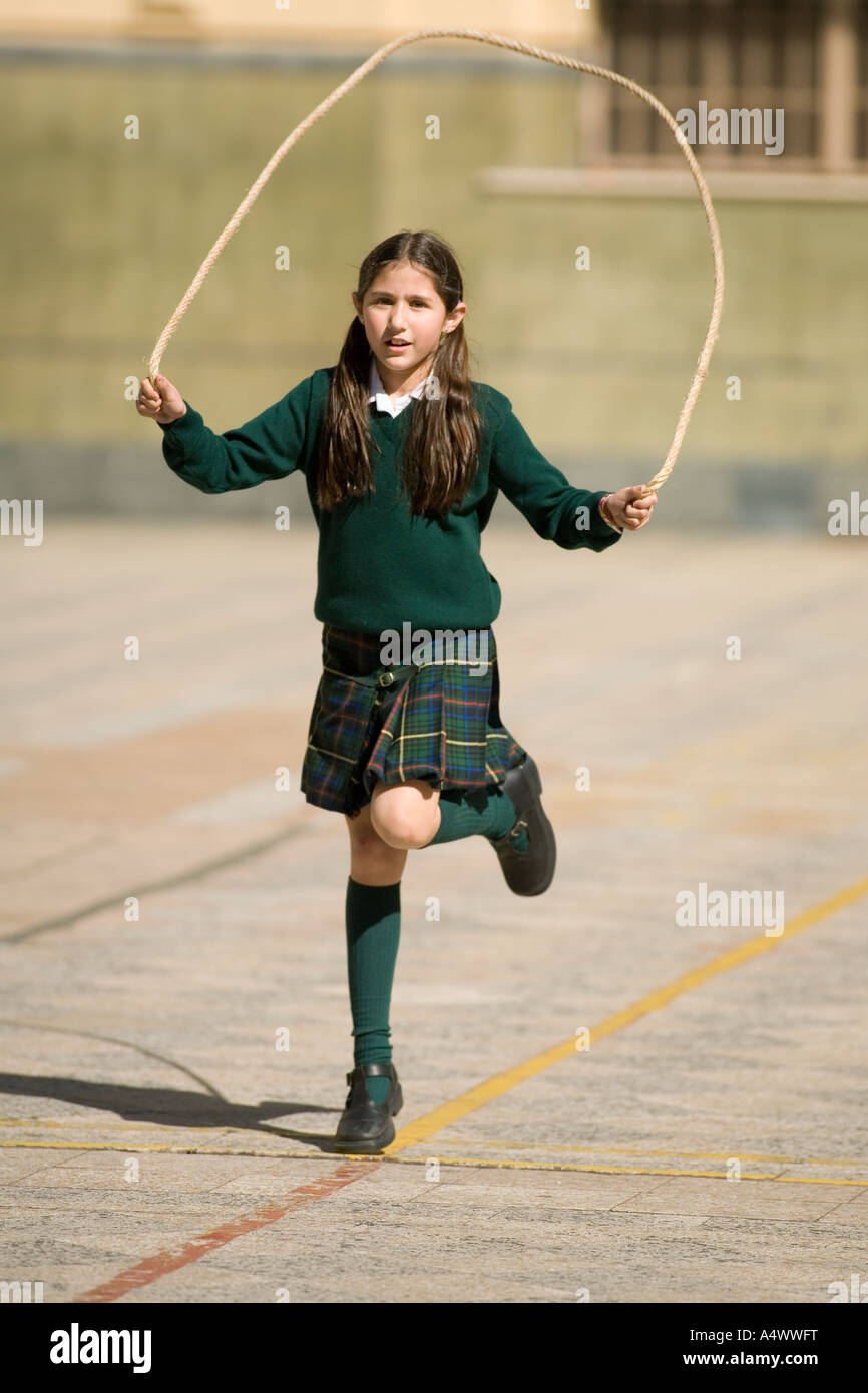 Young student jumping rope in courtyard Stock Photo - Alamy