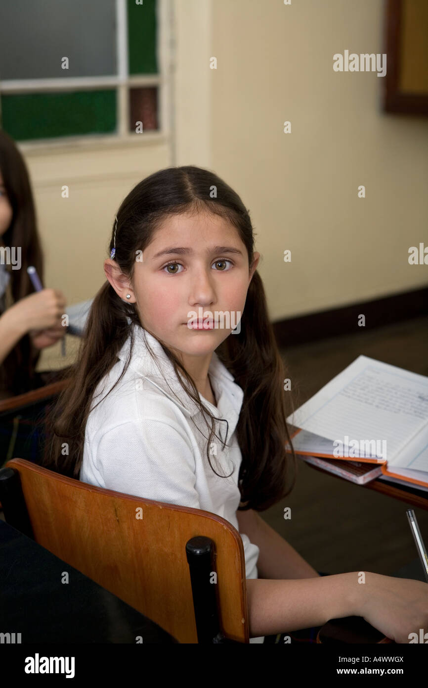 Young student sitting at desk in class Stock Photo - Alamy