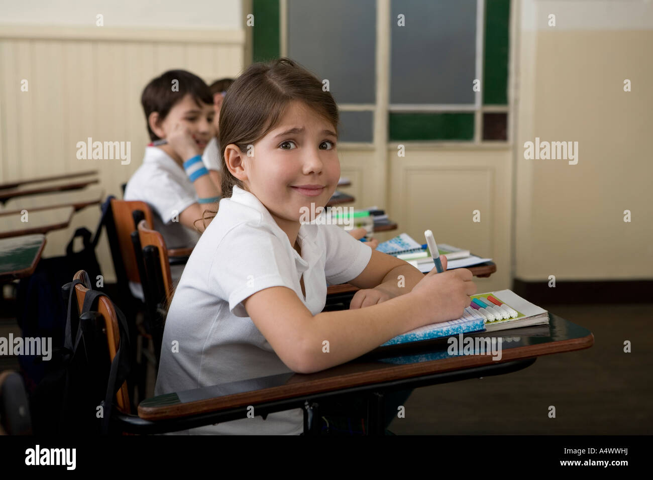Young student sitting at desk in class Stock Photo - Alamy