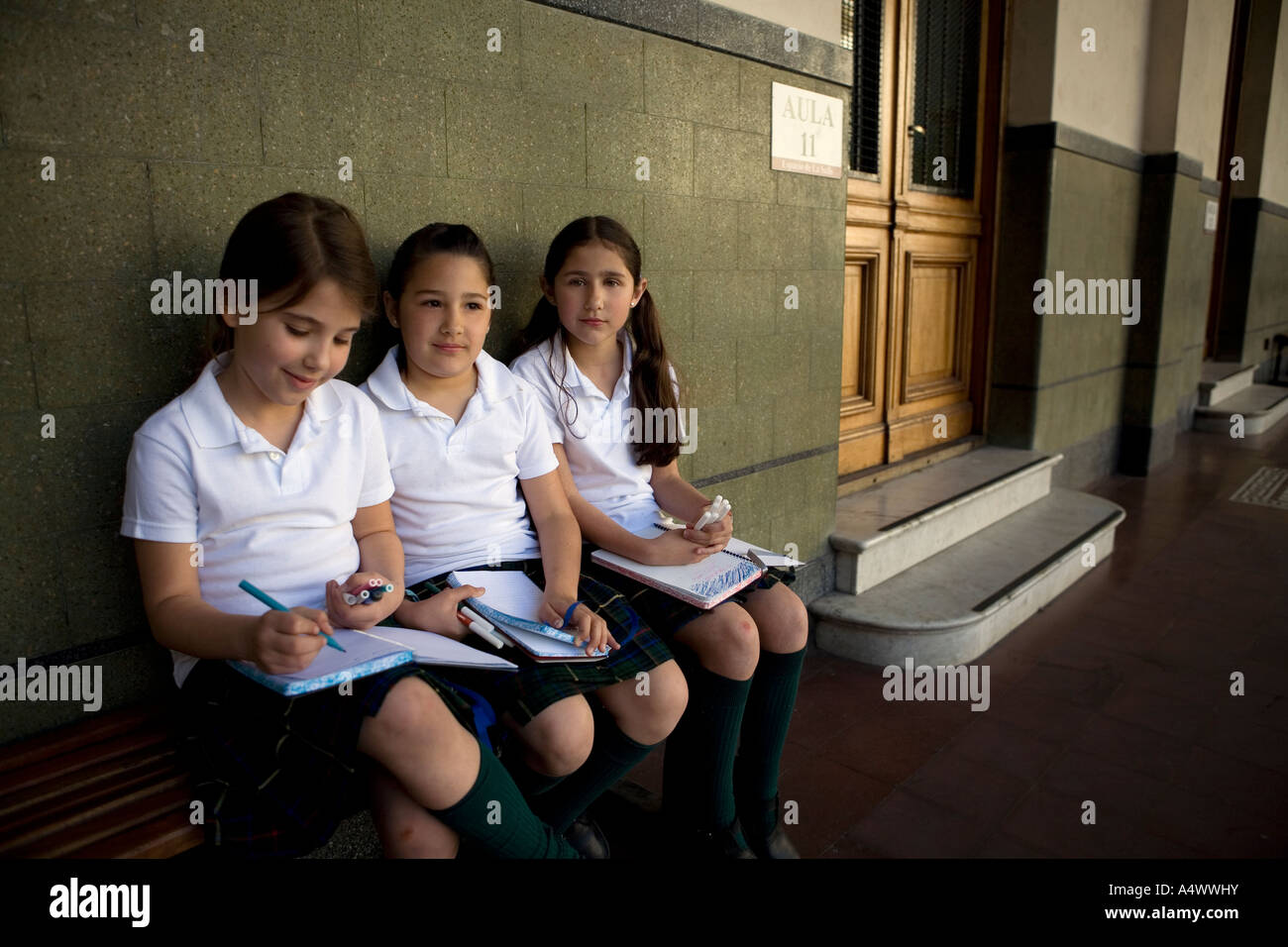 Young students writing outside classroom Stock Photo - Alamy
