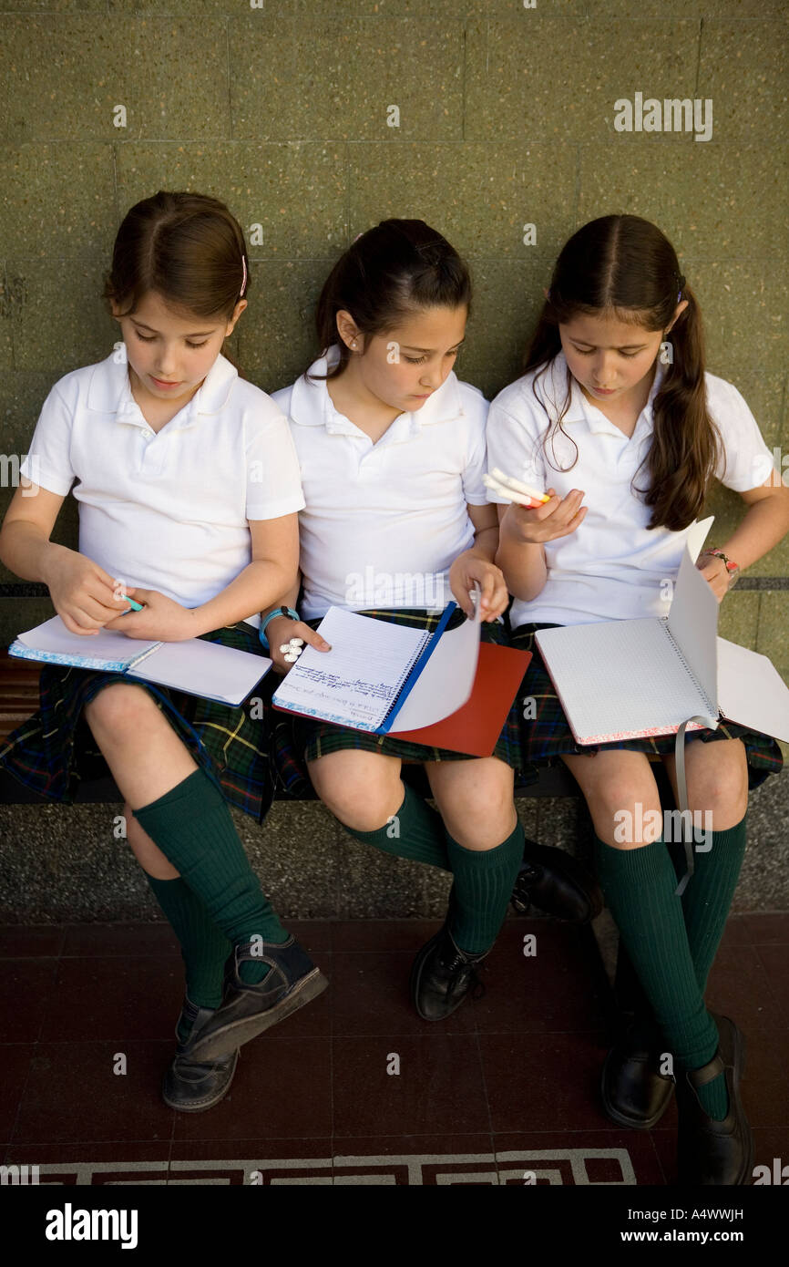 Young students writing outside classroom Stock Photo - Alamy