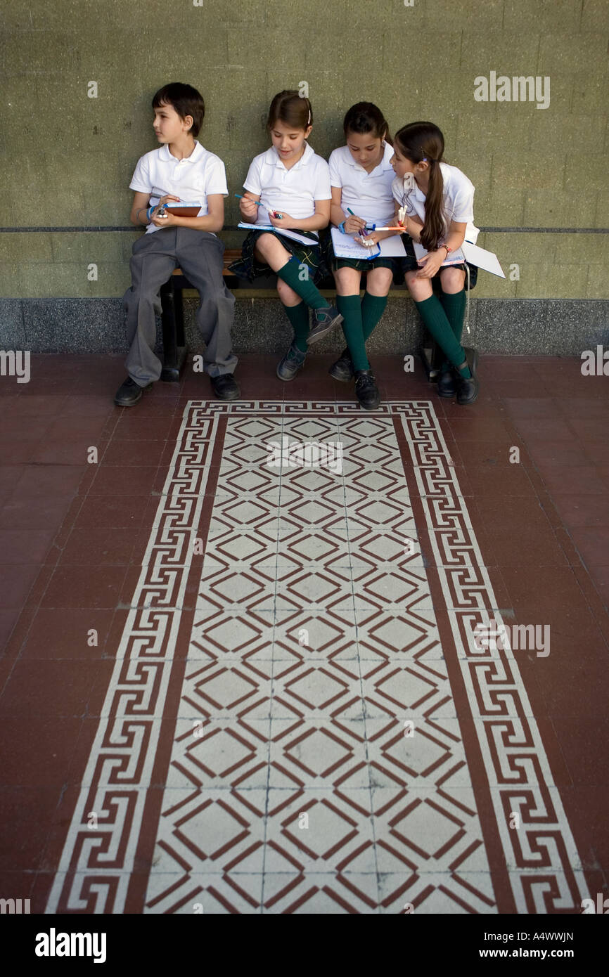 Young students writing outside classroom Stock Photo - Alamy
