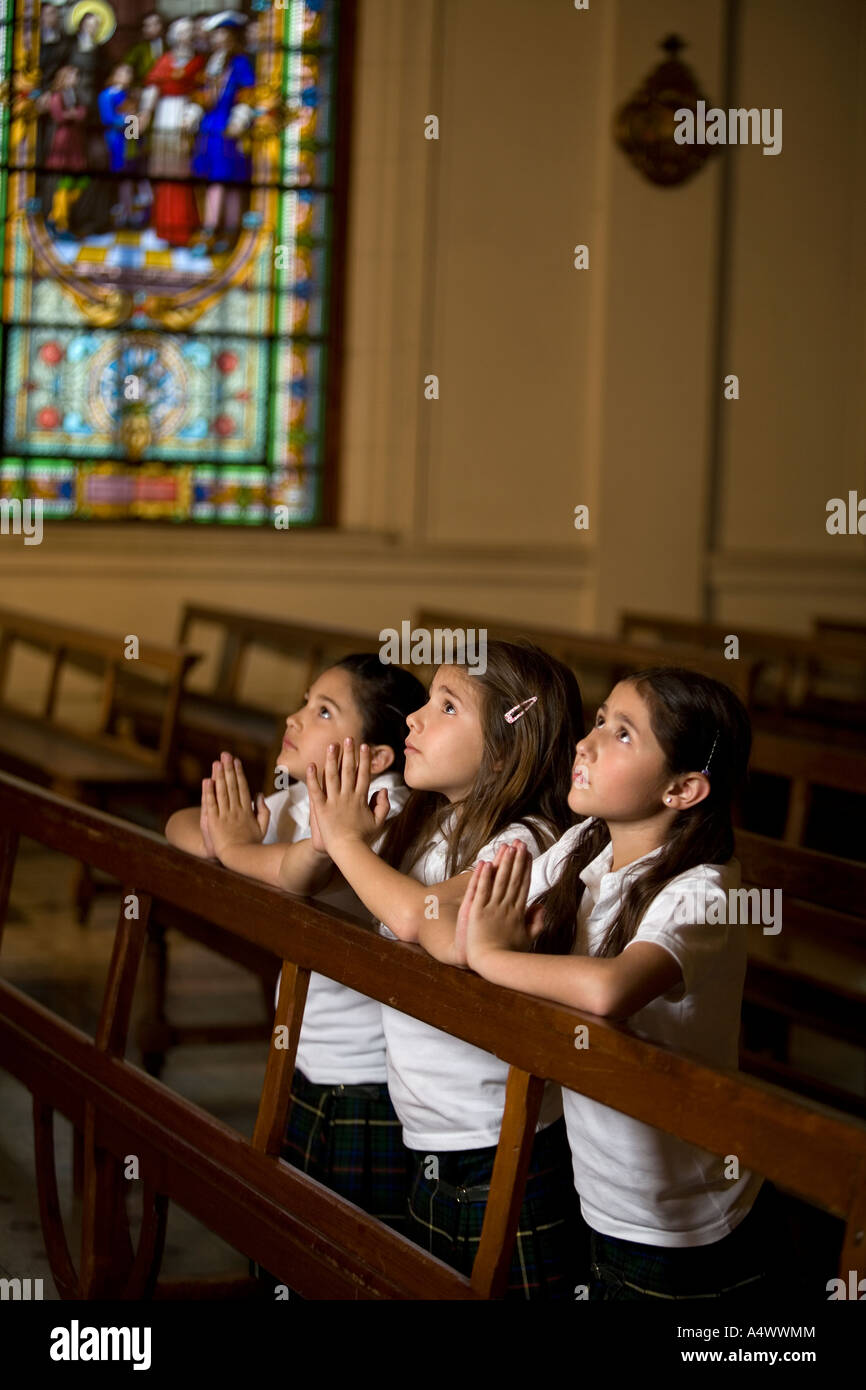 Young students praying in church Stock Photo - Alamy