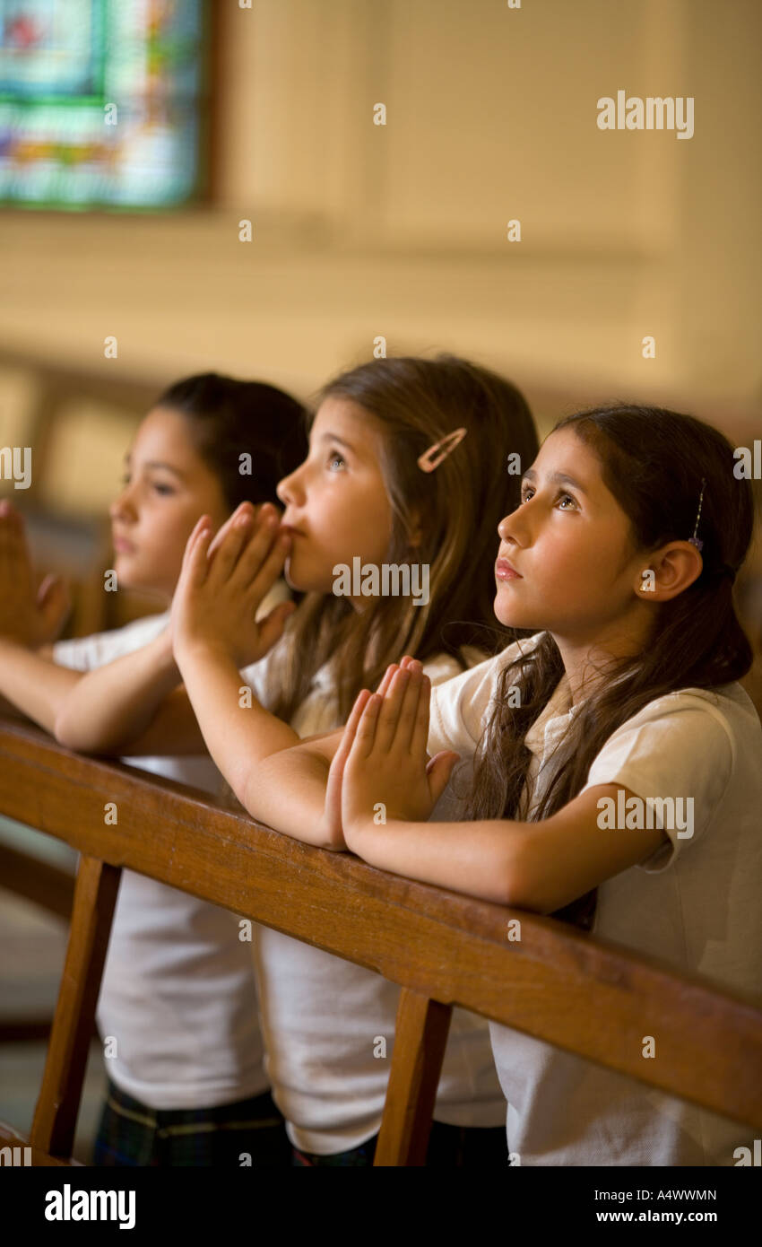 Girl kneeling praying in church hi-res stock photography and images - Alamy