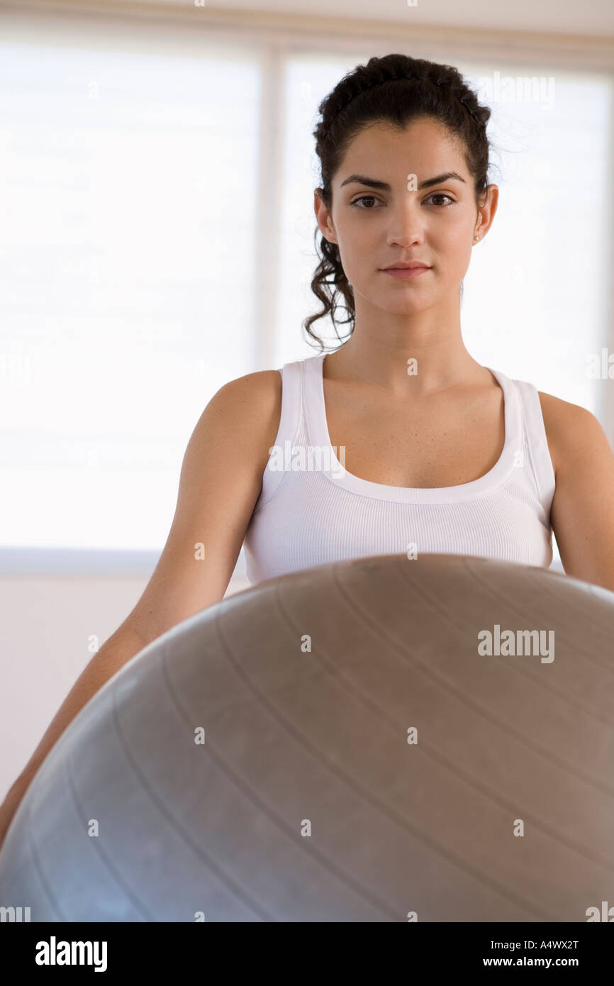 Woman lifting exercise ball Stock Photo - Alamy
