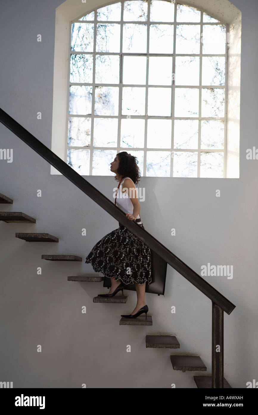 Woman climbing a staircase Stock Photo - Alamy
