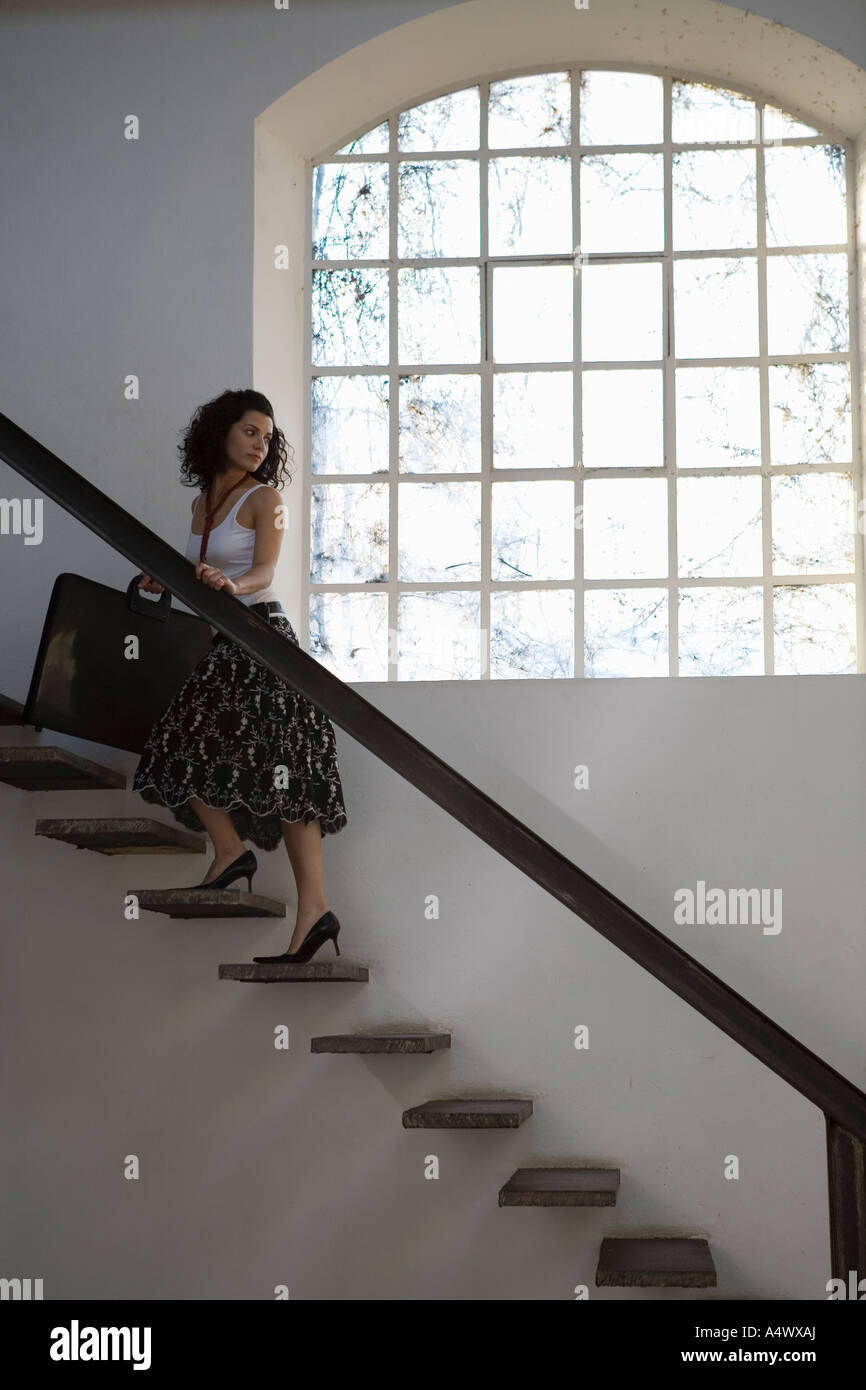 Woman climbing a staircase Stock Photo - Alamy