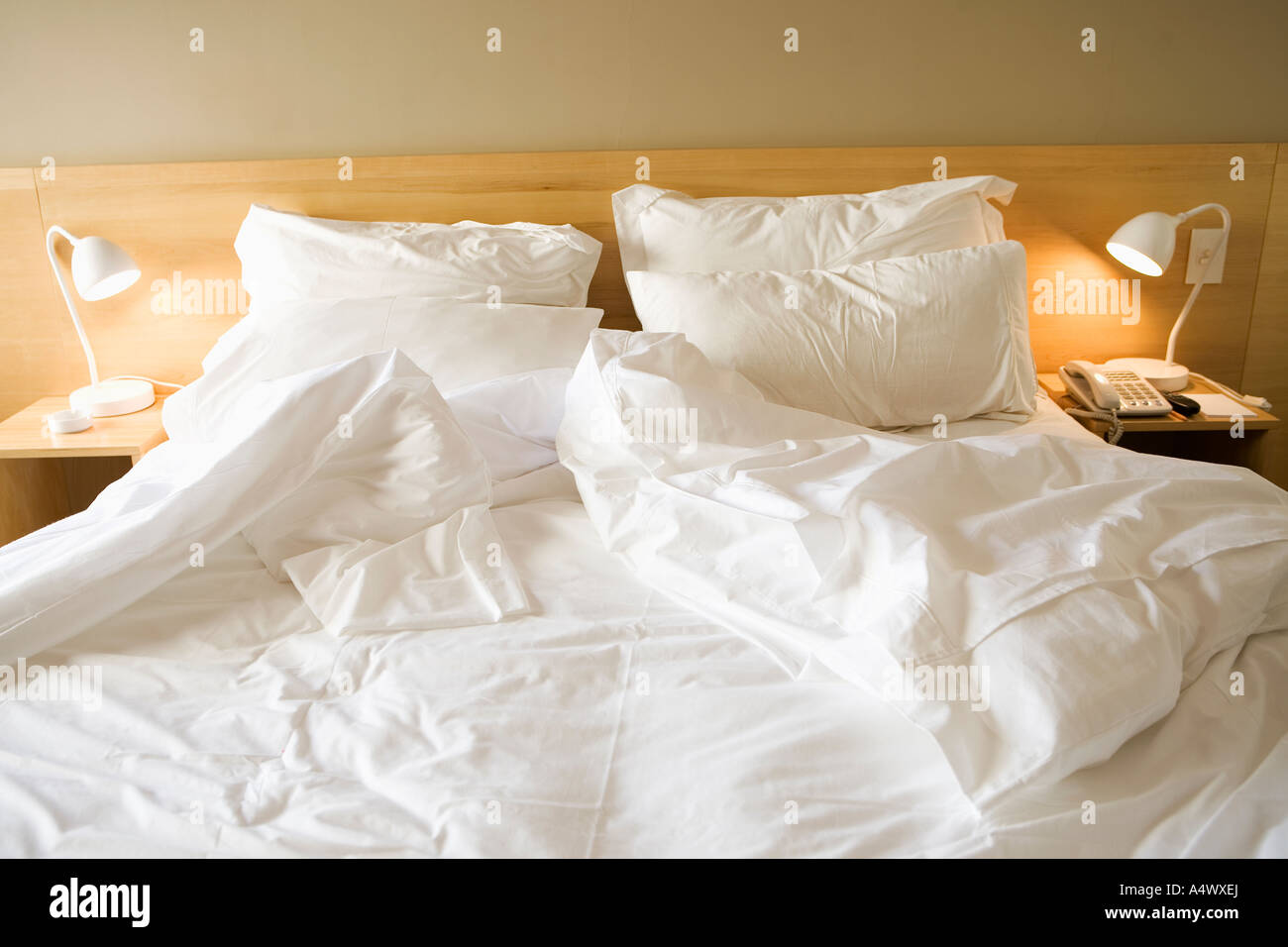 Messy bed in hotel room Stock Photo - Alamy
