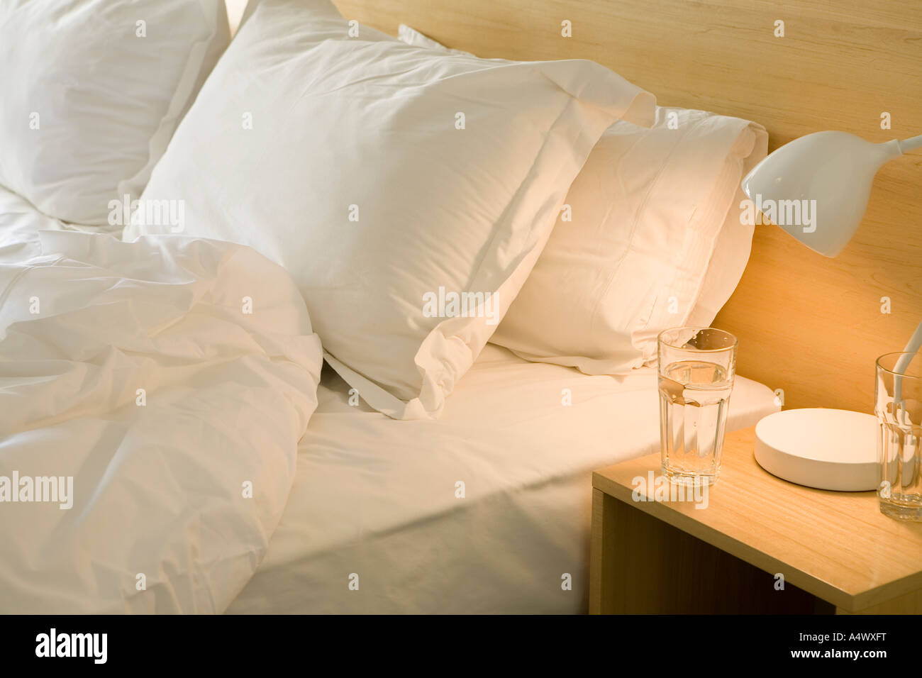 Glass of water on bedside table Stock Photo - Alamy