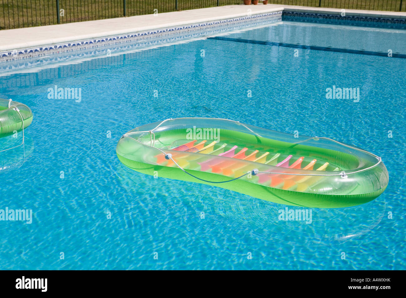 Colorful inflatable raft in swimming pool Stock Photo - Alamy