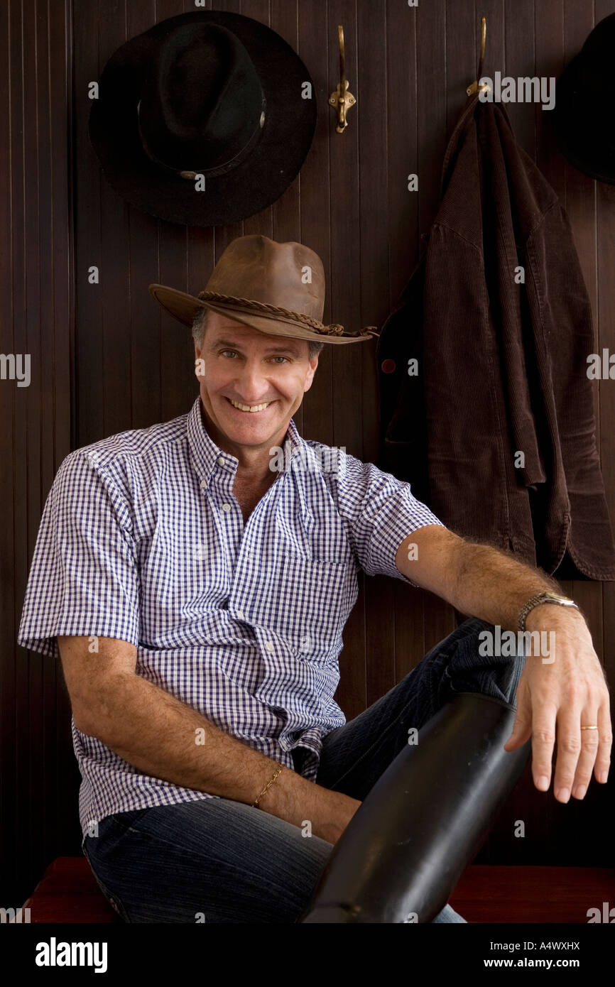 Man wearing riding boots indoors Stock Photo - Alamy
